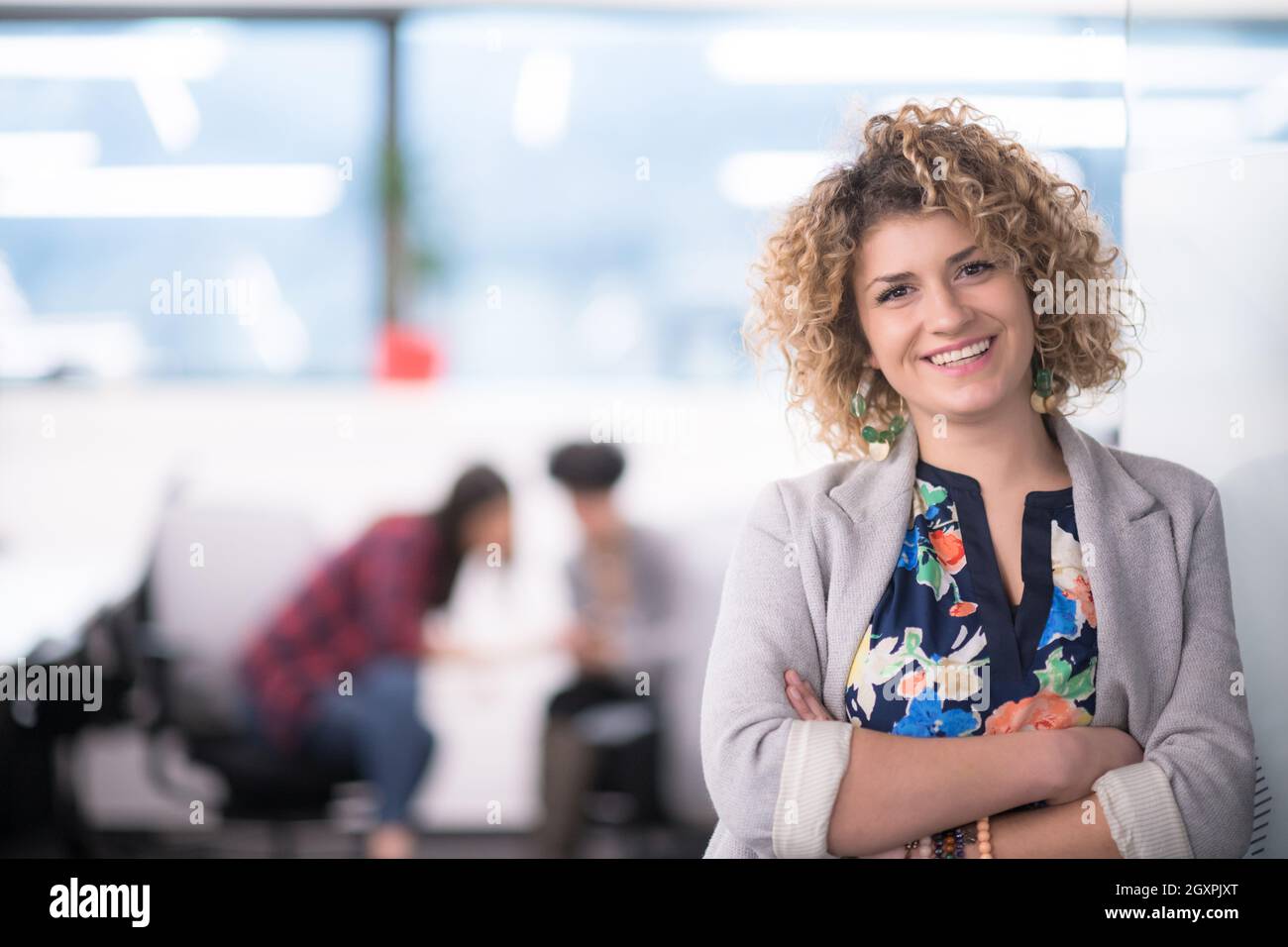 Portrait of successful female software developer with a curly hairstyle ...
