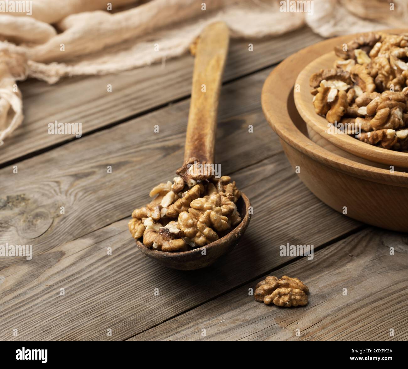 peeled walnuts in a wooden plate on the table, top view Stock Photo - Alamy