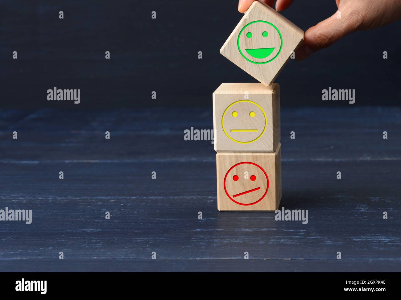 wooden blocks with different emotions from smile to sadness and a woman ...
