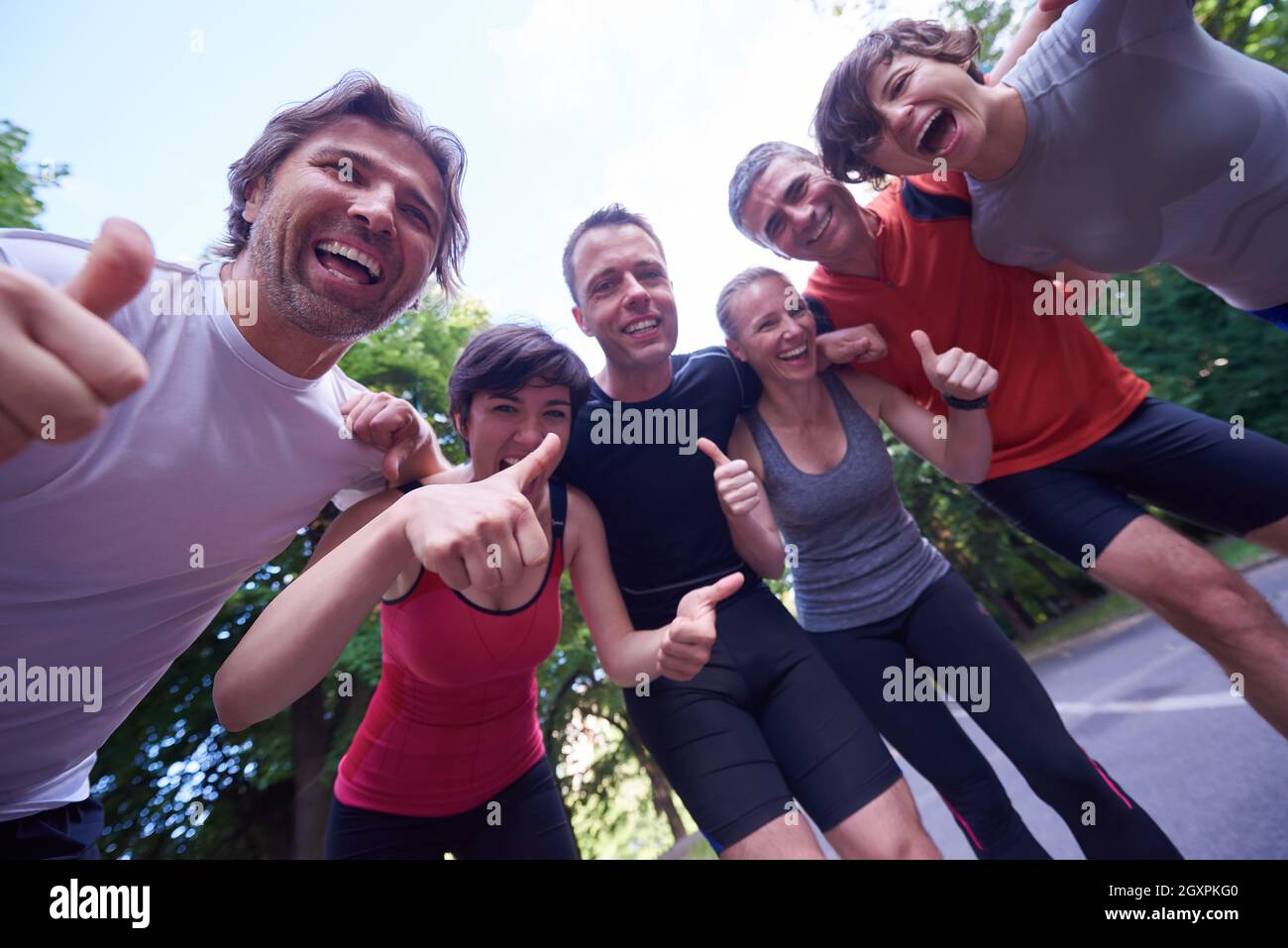 jogging people group, friends have fun, hug and stack hands together ...