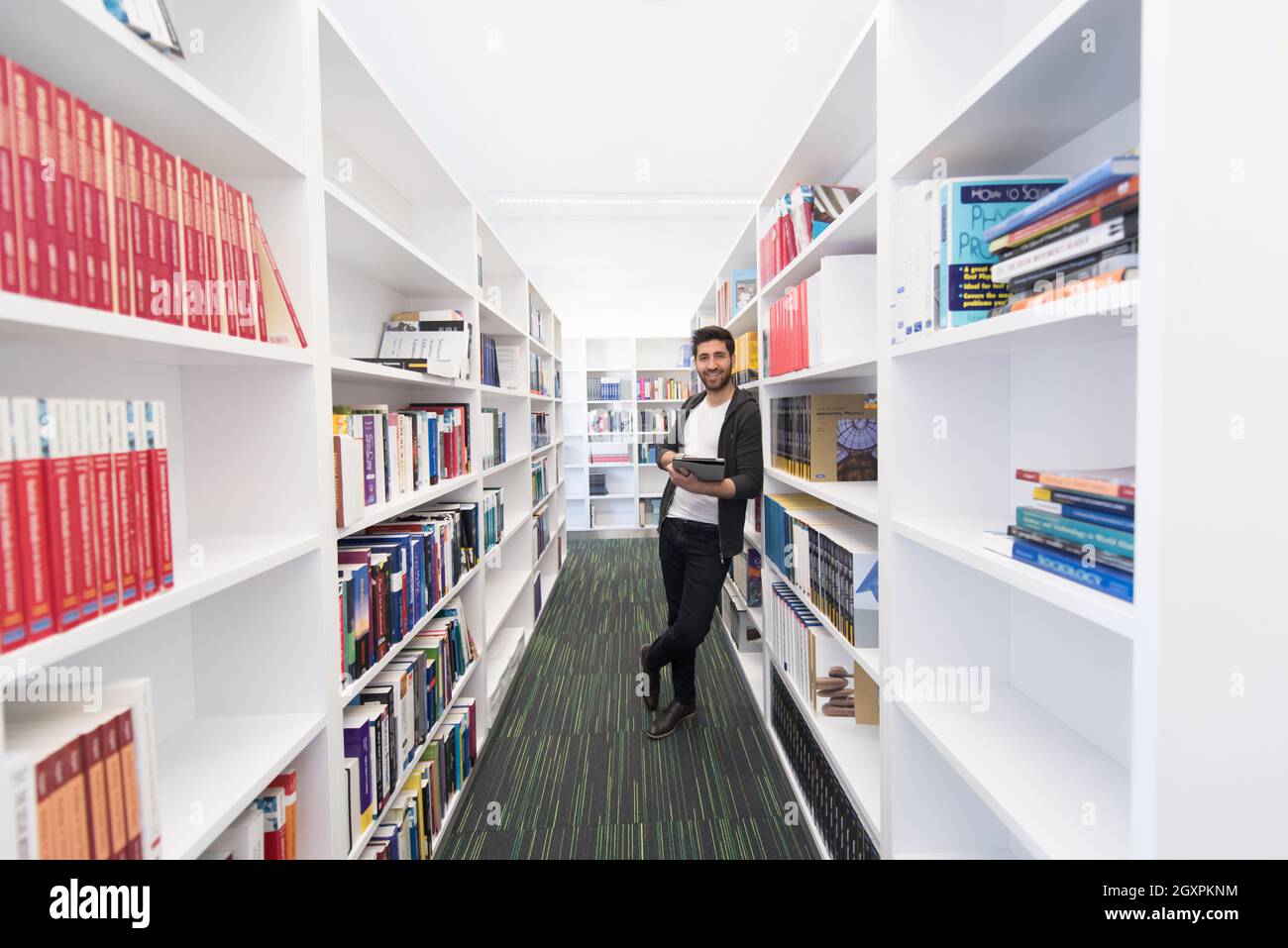 portrait of student in school library with tablet computer. Database ...