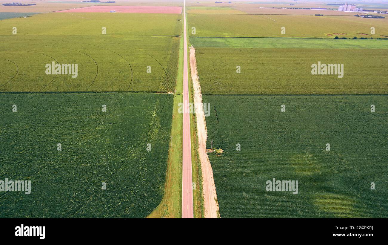 Aerial long straight road cutting across fields of farmland Stock Photo ...