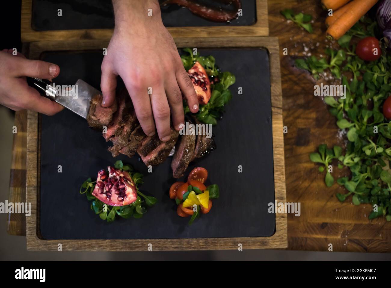 top view of Chef hands in hotel or restaurant kitchen serving beef ...