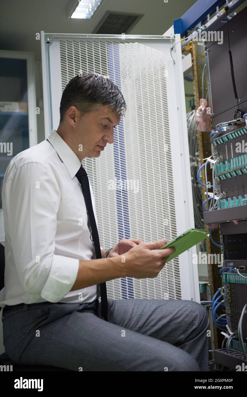 network engineer working in server room, corporate business man working ...