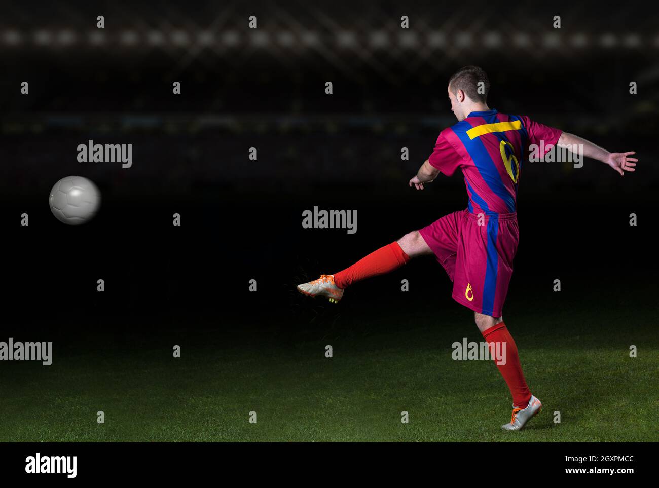 soccer player doing kick with ball on football stadium field Stock ...