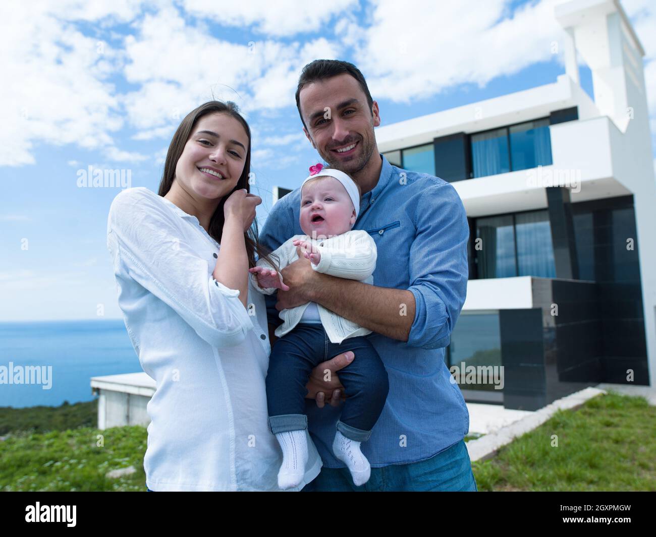 happy young family couple with beautiful new born baby have fun at ...