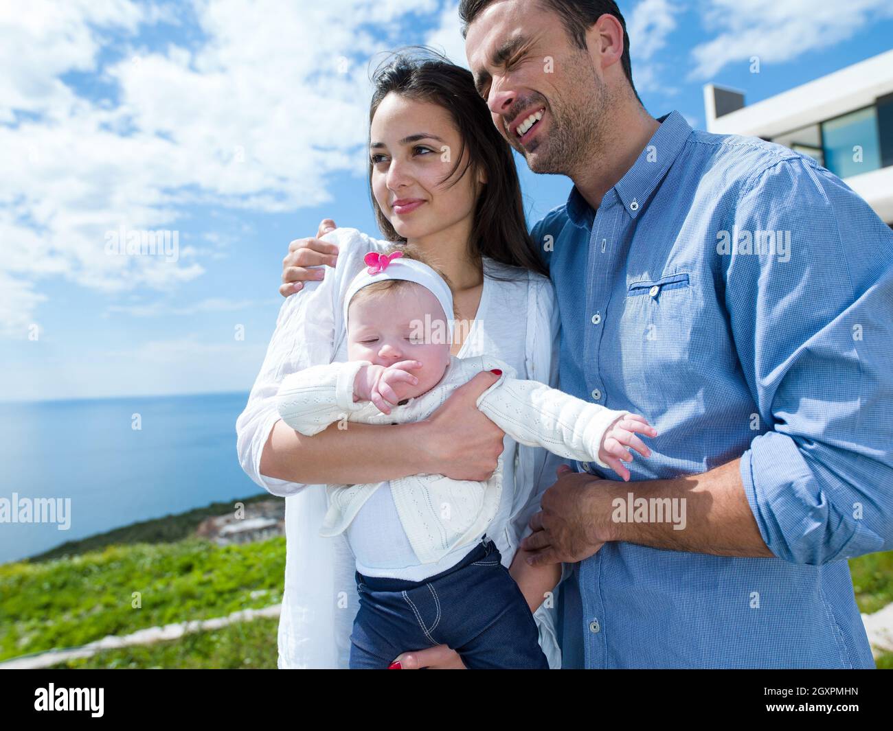 happy young family couple with beautiful new born baby have fun at ...