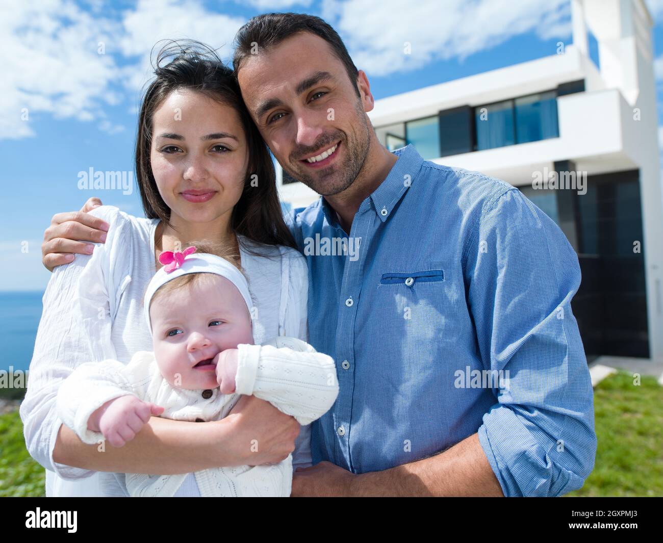 happy young family couple with beautiful new born baby have fun at ...