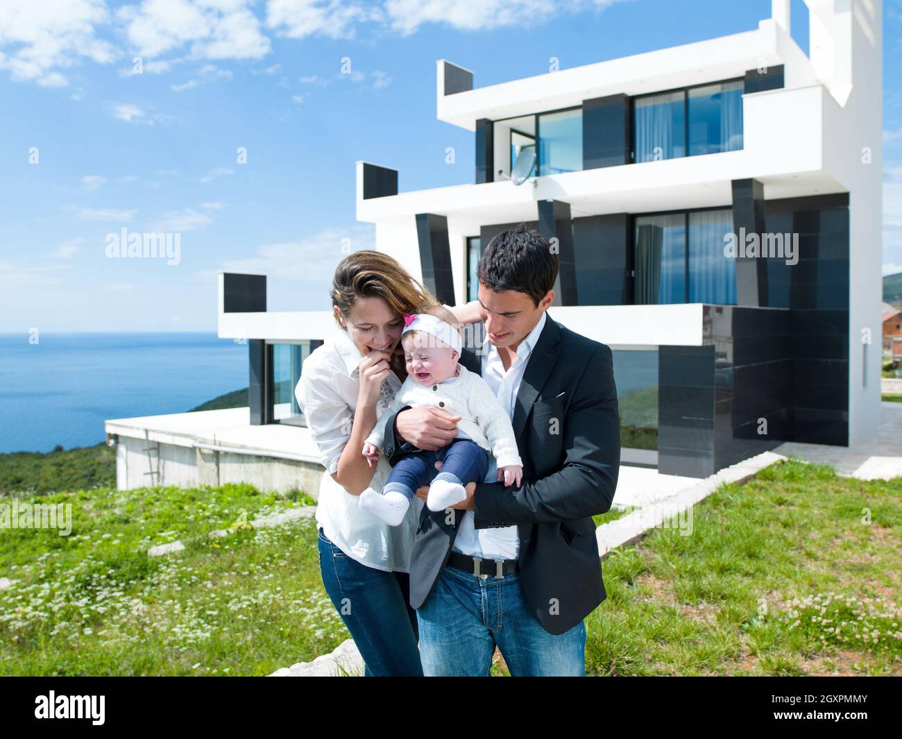 happy young family couple with beautiful new born baby have fun at ...