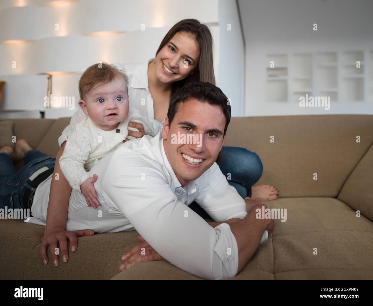 happy young family couple with beautiful new born baby have fun at ...