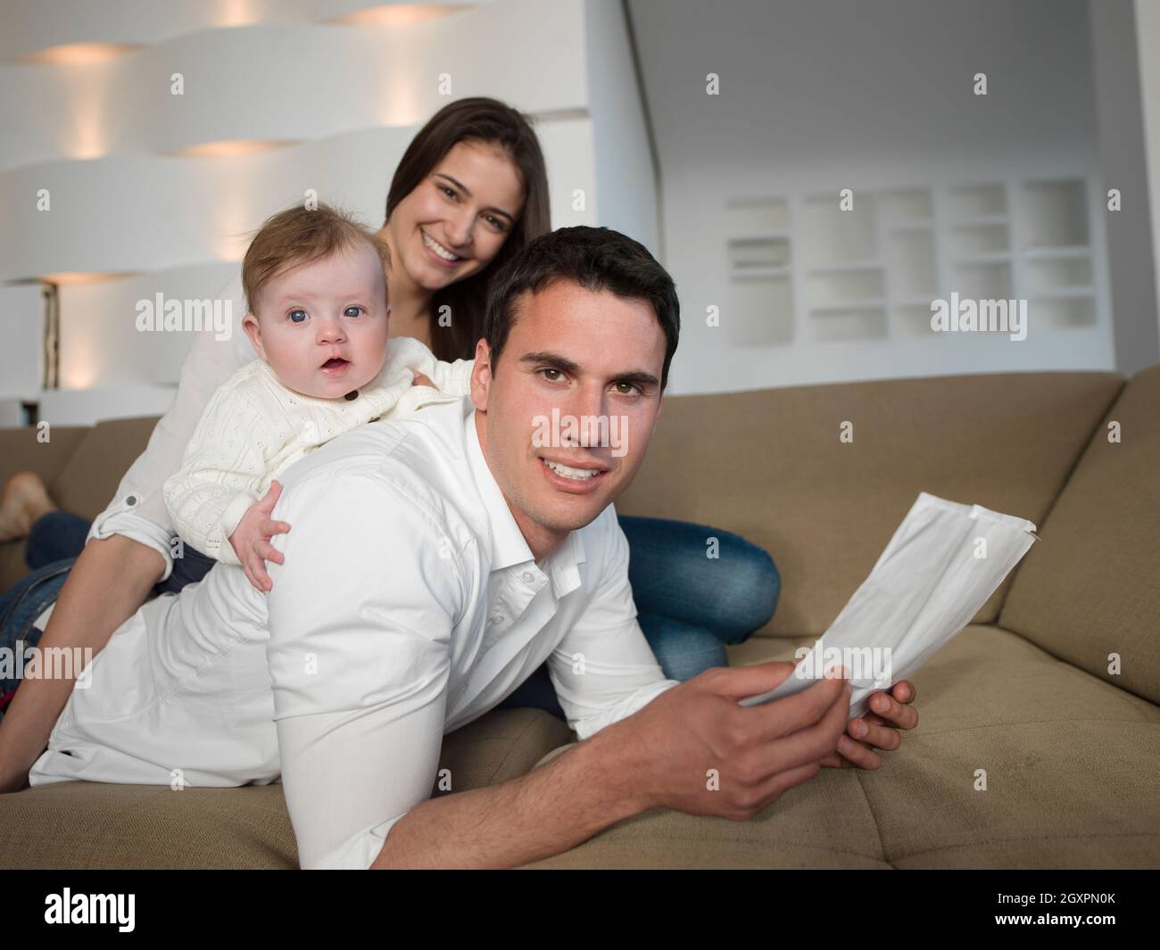 happy young family couple with beautiful new born baby have fun at ...