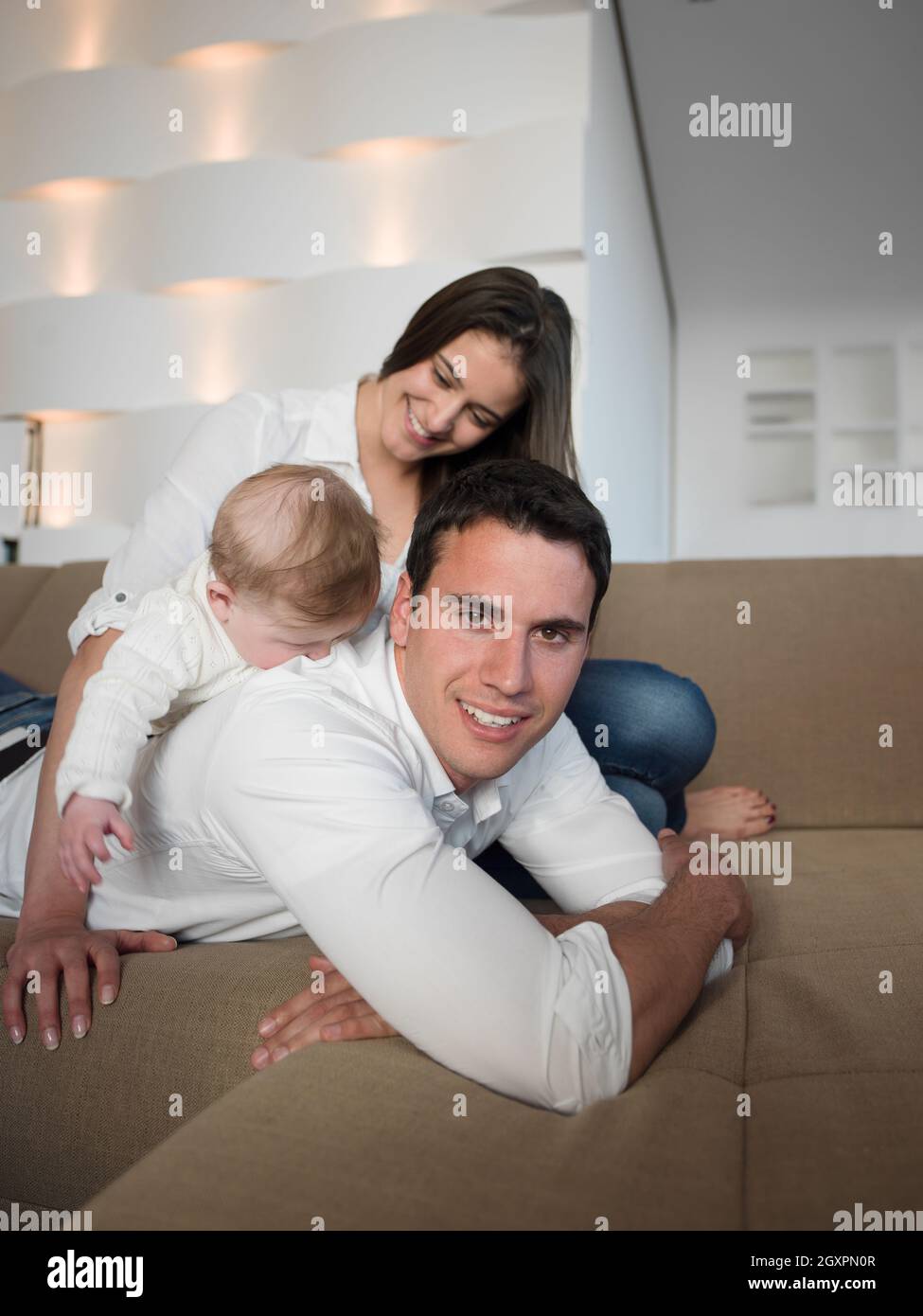 happy young family couple with beautiful new born baby have fun at ...