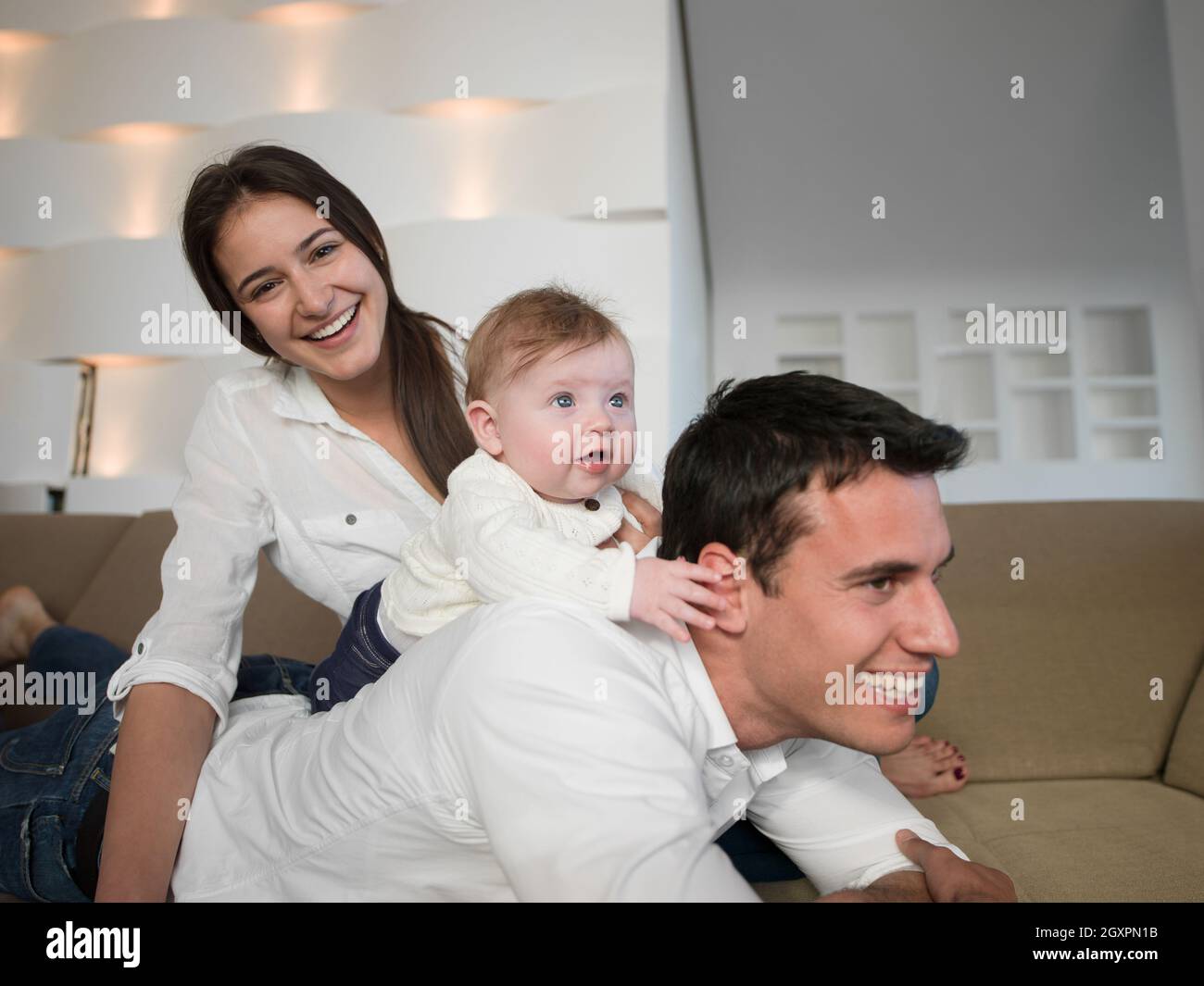 happy young family couple with beautiful new born baby have fun at ...