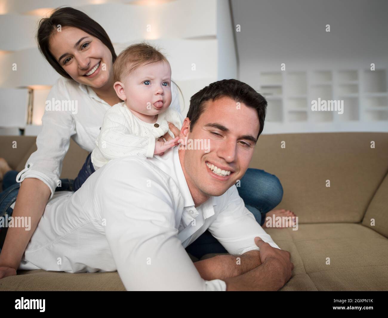 happy young family couple with beautiful new born baby have fun at ...