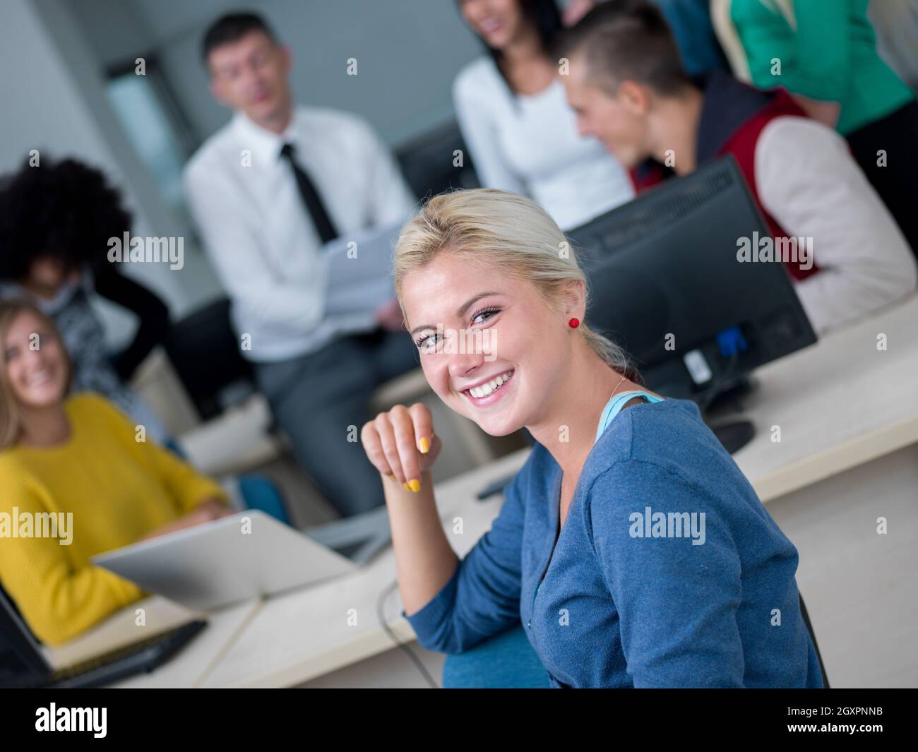 group of students with teacher in computer lab classrom learrning lessons, get help and support ...