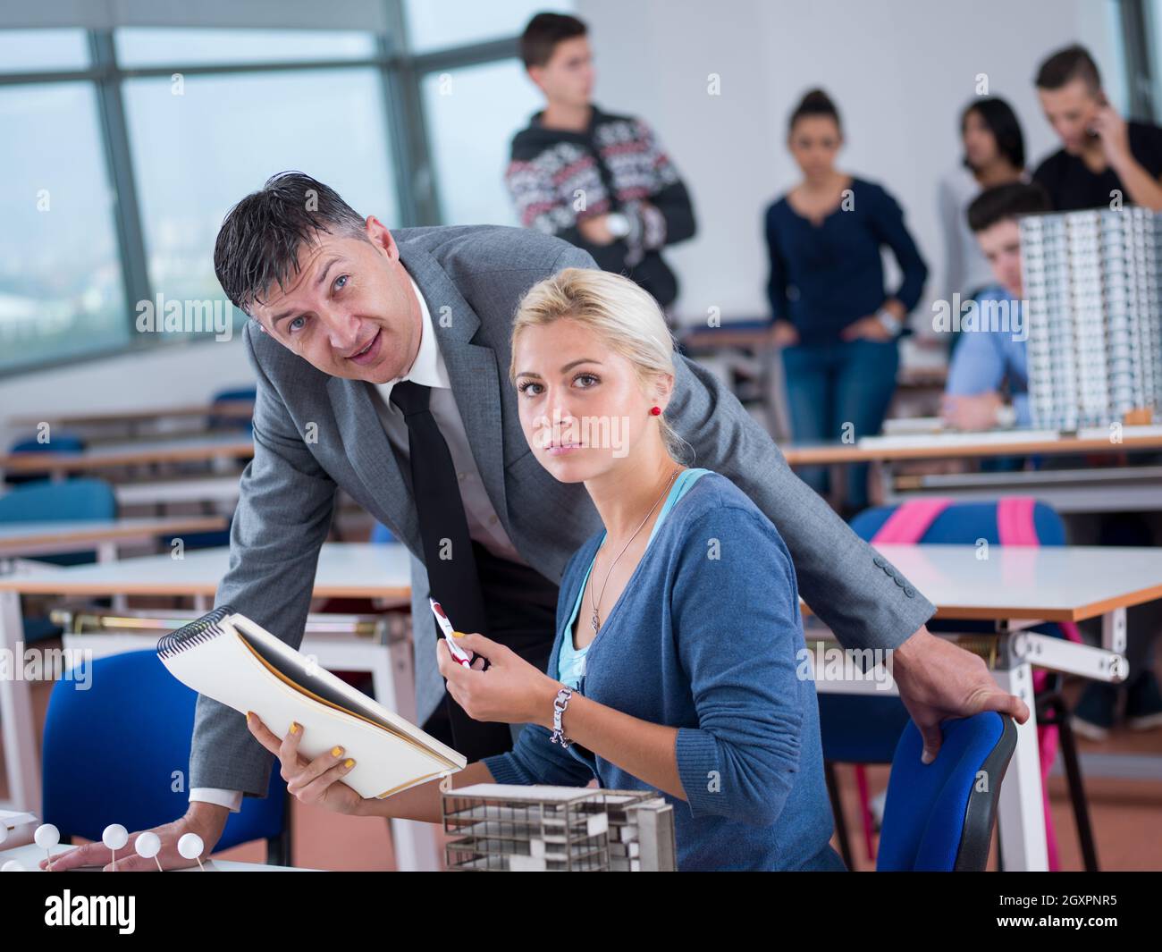 group of students with teacher in computer lab classrom learrning lessons, get help and support ...