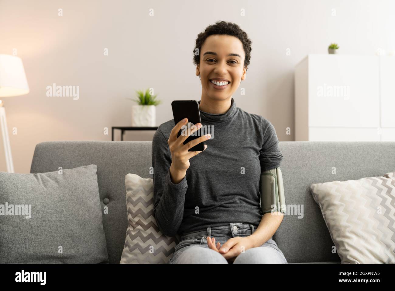 Blood Pressure Check Using Smart Monitor. African Patient Woman Stock ...