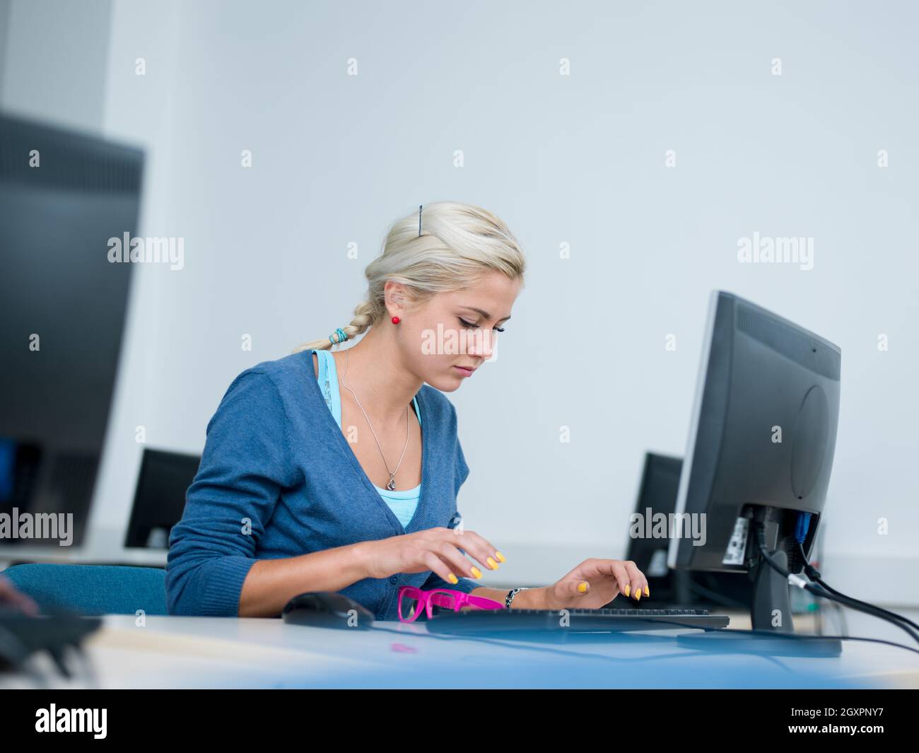 student woman in computer lab classroom working on project Stock Photo ...