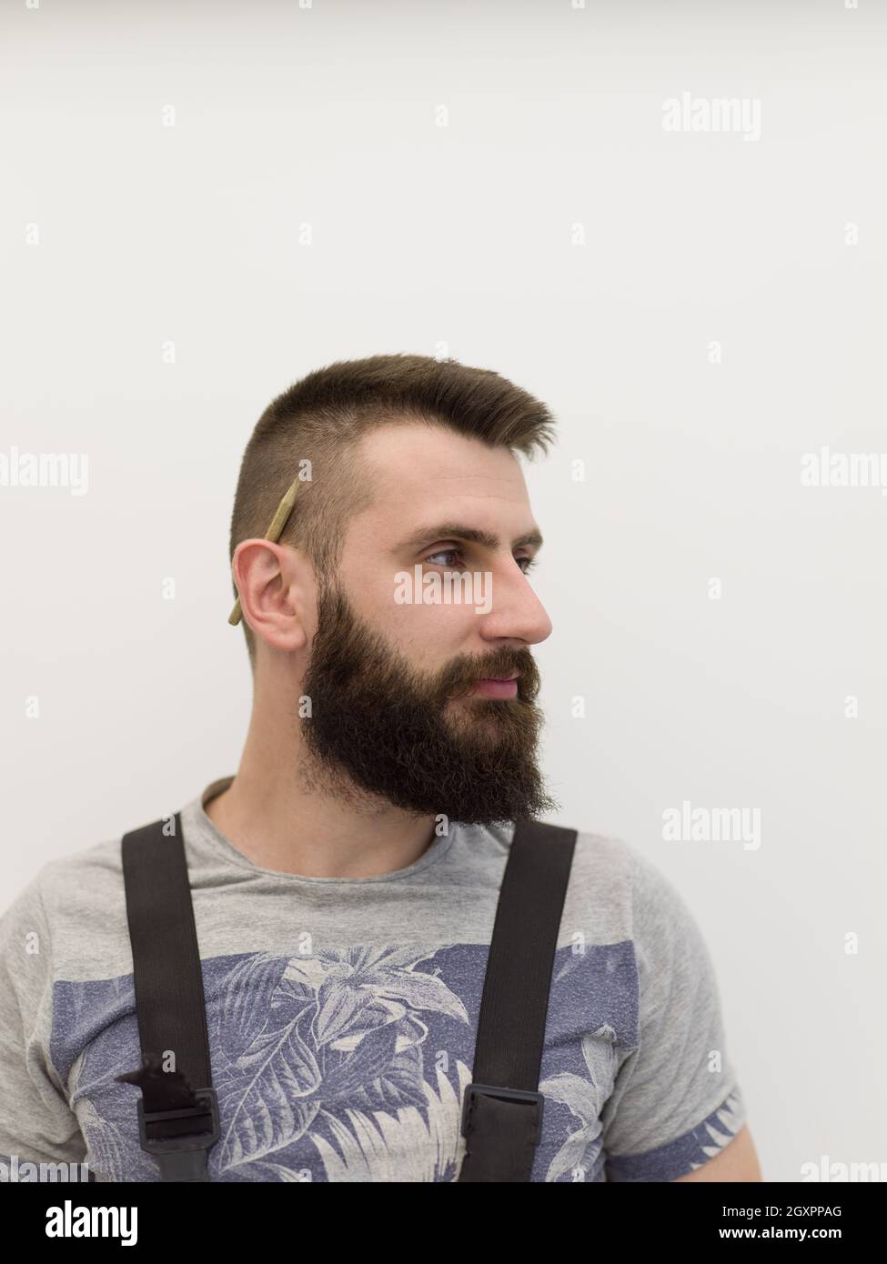 portrait of bearded hipster handyman with pen behind ear isolated on ...