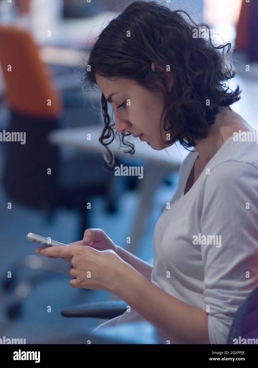 Businesswoman typing on phone while browsing internet at work in office ...
