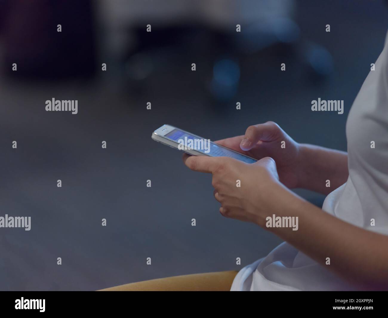 Businesswoman typing on phone while browsing internet at work in office ...