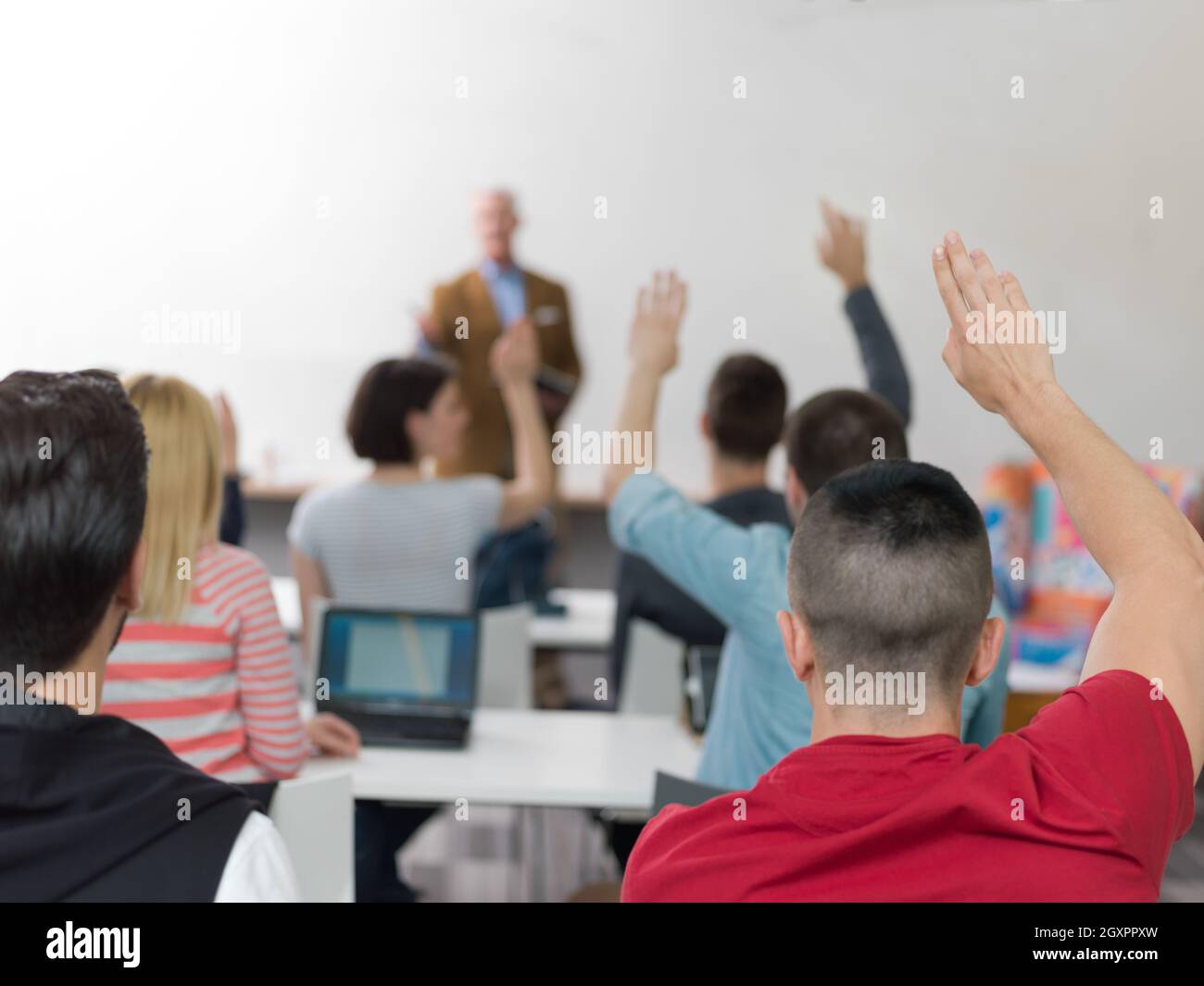 senior teacher teaching lessons, smart students group raise hands up in ...