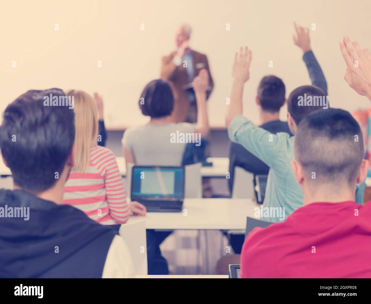senior teacher teaching lessons, smart students group raise hands up in ...