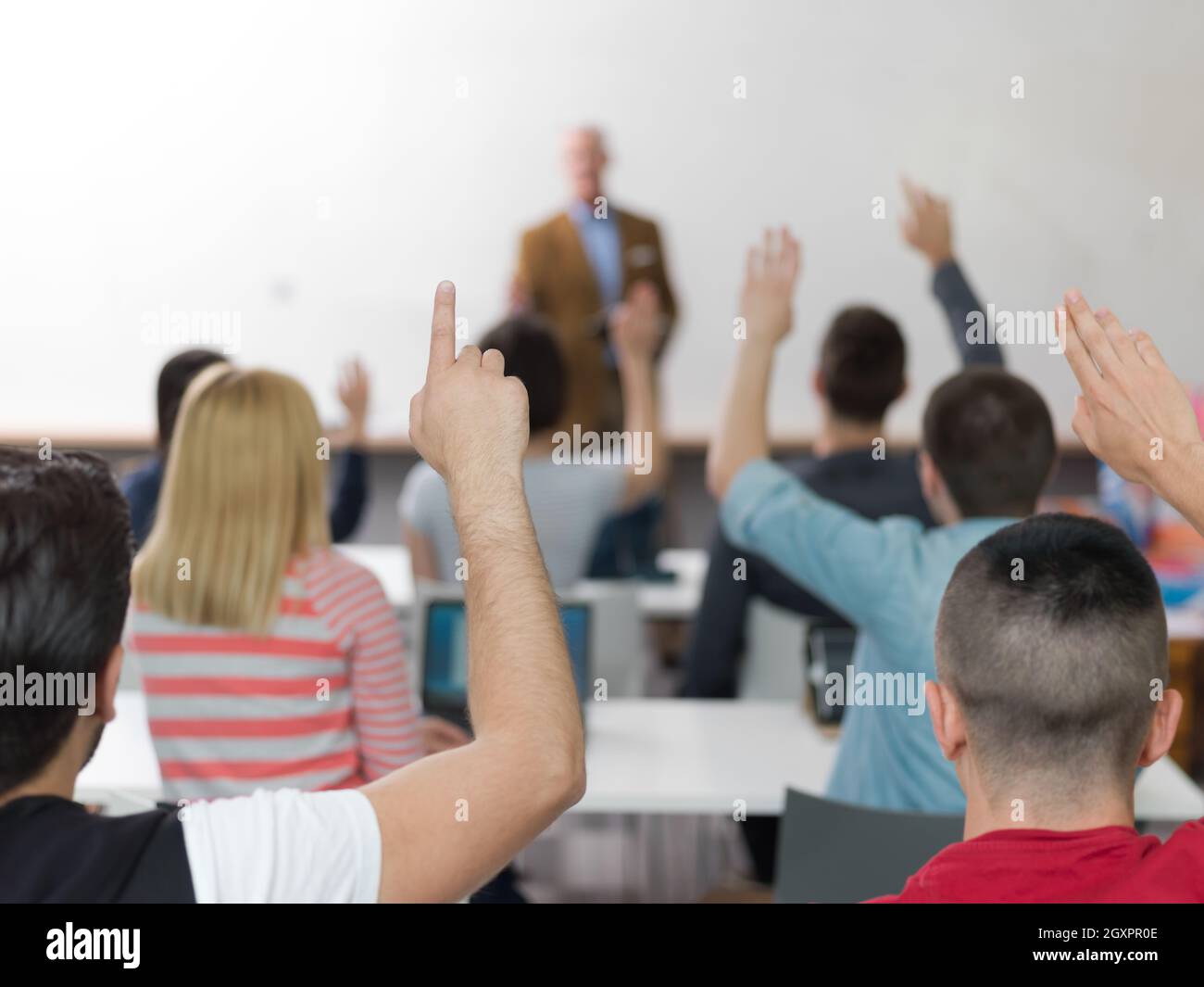senior teacher teaching lessons, smart students group raise hands up in ...