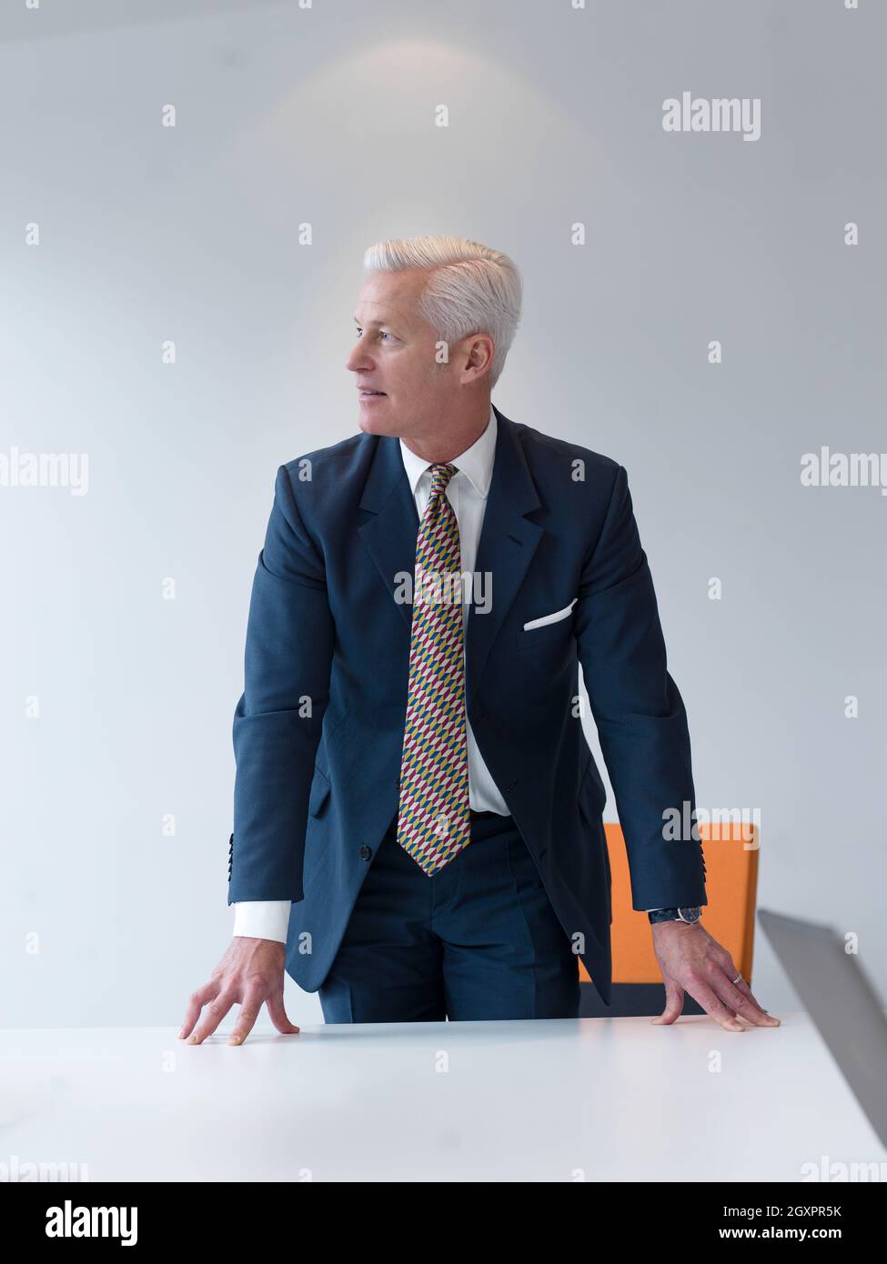 Boss sitting behind desk standing hi-res stock photography and images ...