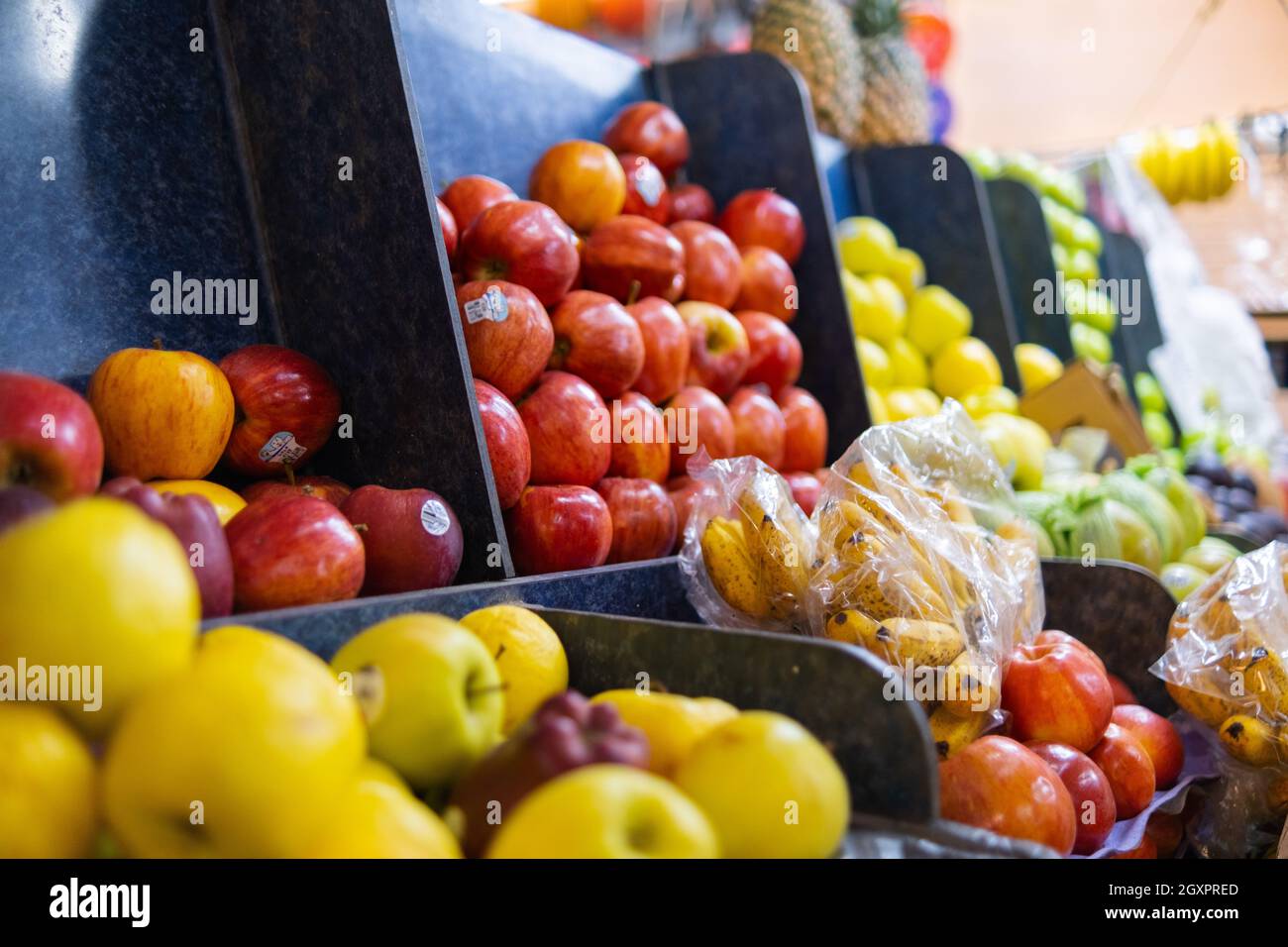 Close-up of colorful fruit stand with fresh yellow and red apples ...
