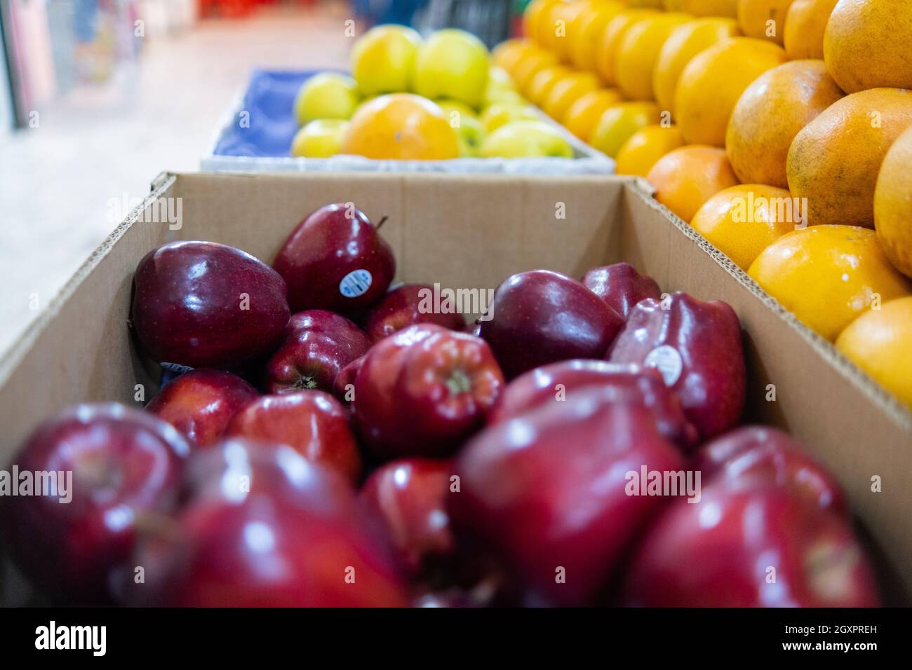 Close-up of colorful fruit stand with fresh red and yellow apples and ...