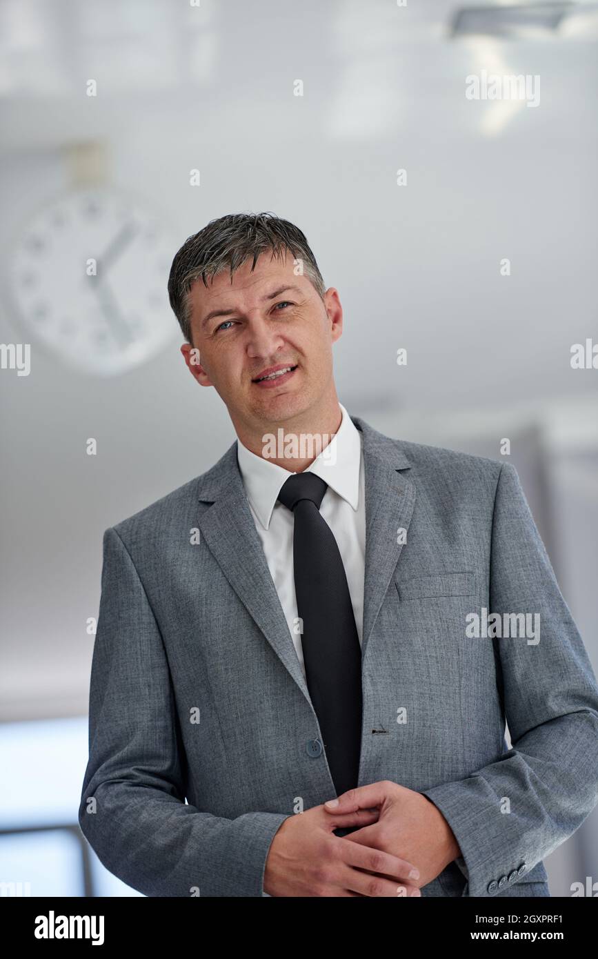 portrait of middle aged business man at modern office space indoors ...