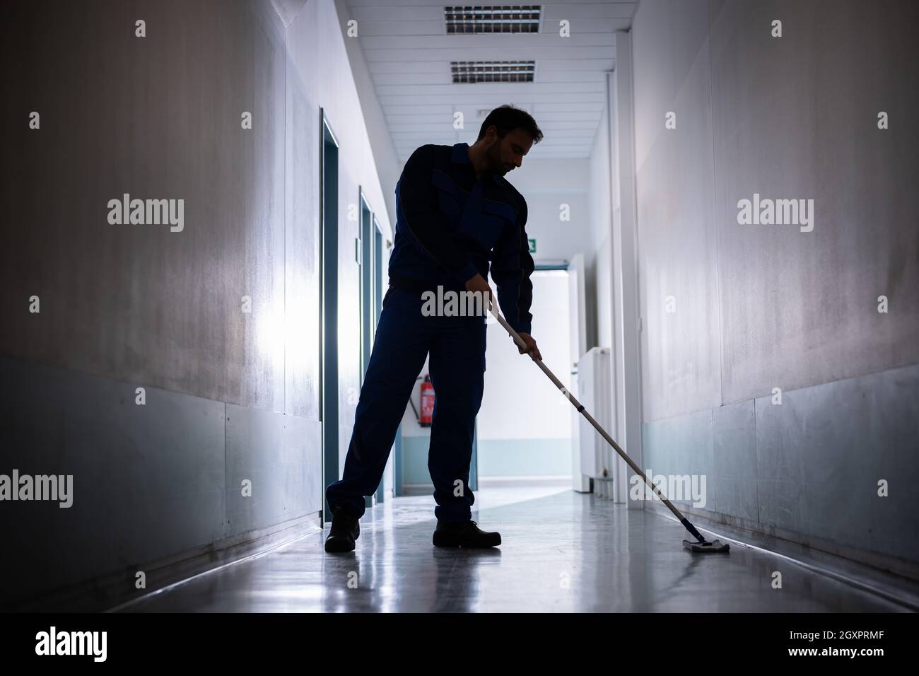 Professional Office Janitor Worker Cleaning Floor With Mop Stock Photo ...