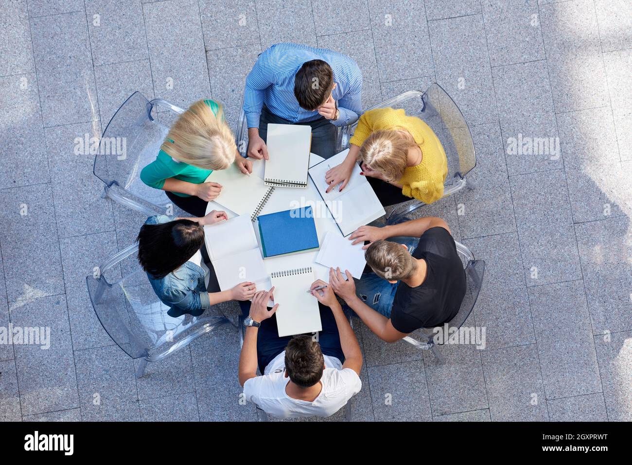 top view, group of students together at school table working homework ...