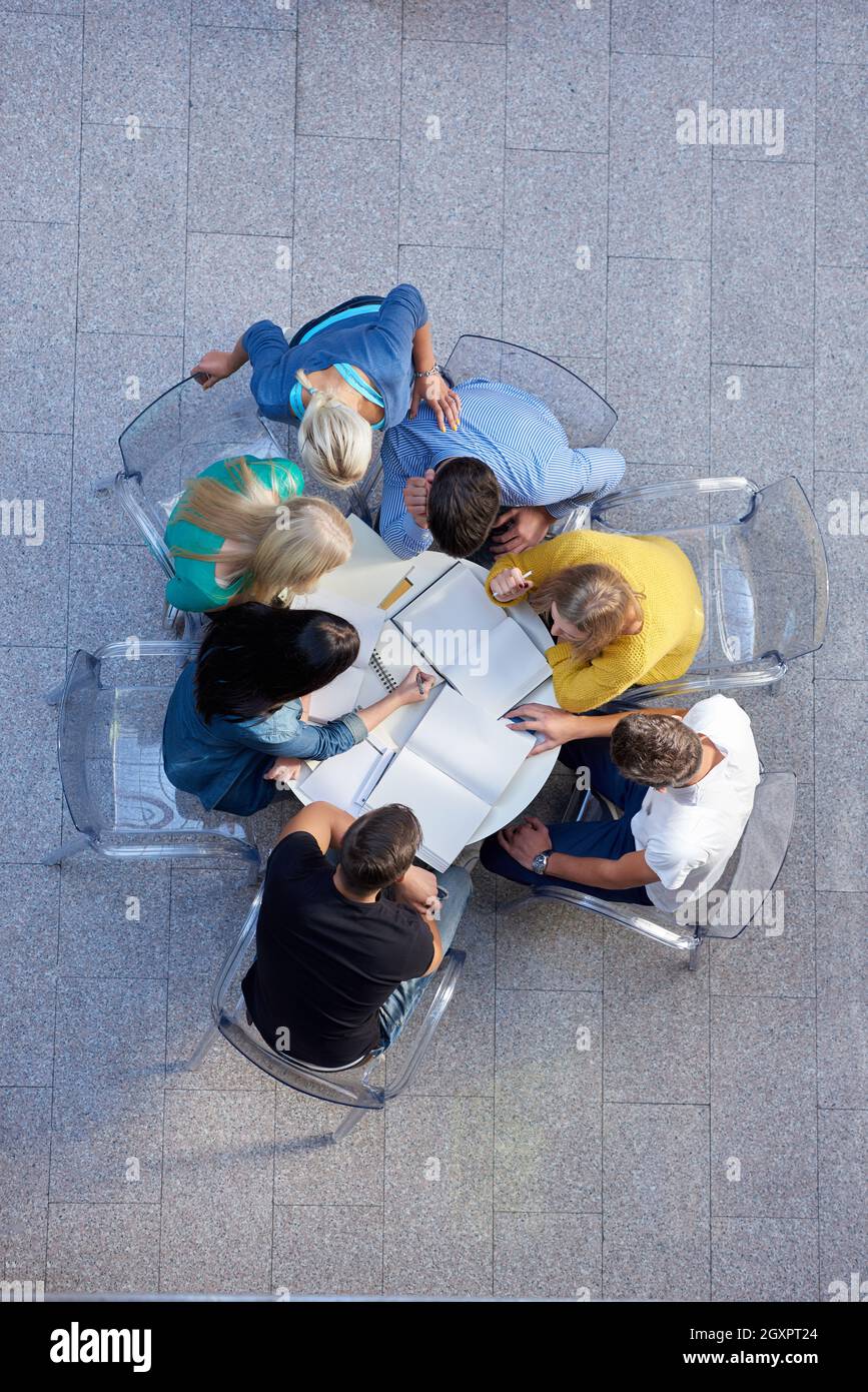 top view, group of students together at school table working homework ...