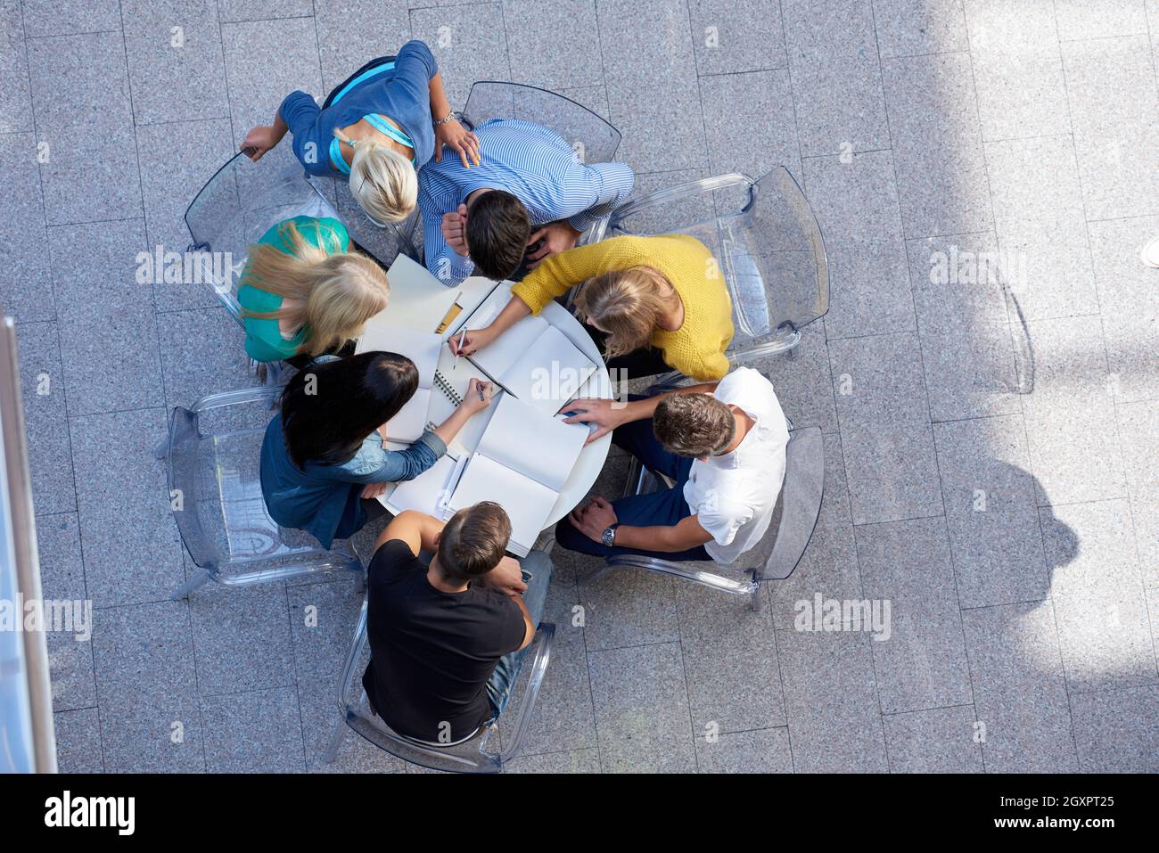 top view, group of students together at school table working homework ...