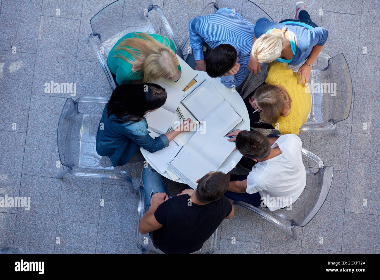 top view, group of students together at school table working homework ...