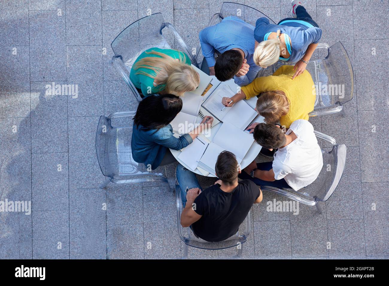 top view, group of students together at school table working homework ...