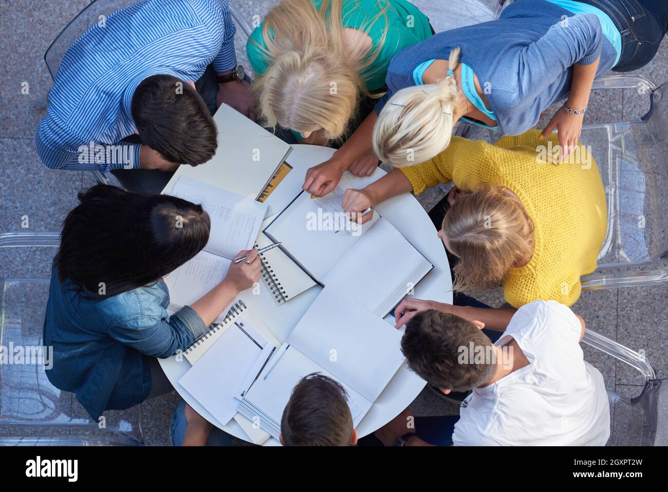 top view, group of students together at school table working homework ...