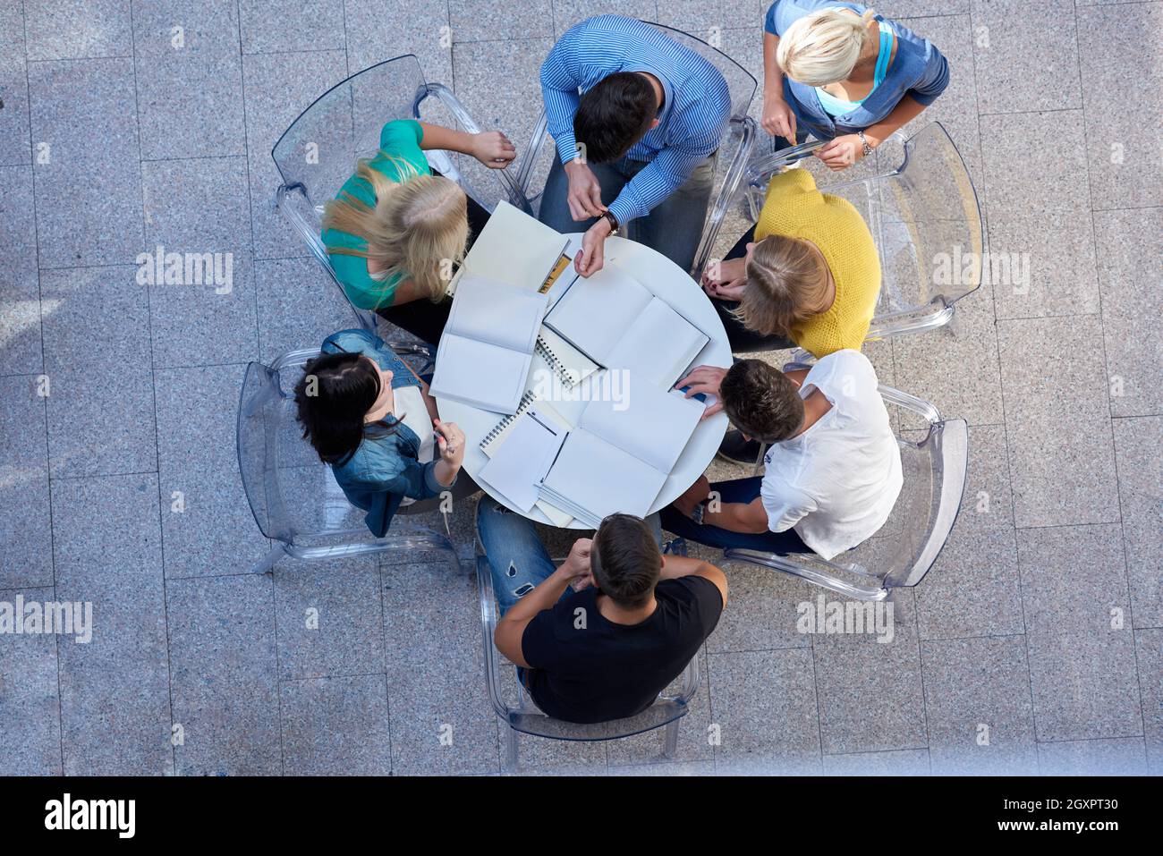 top view, group of students together at school table working homework ...