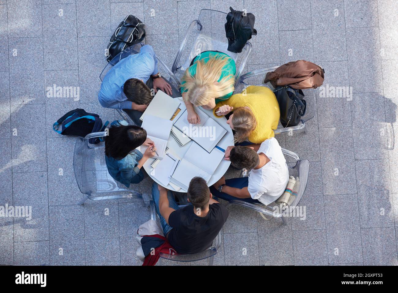 top view, group of students together at school table working homework ...
