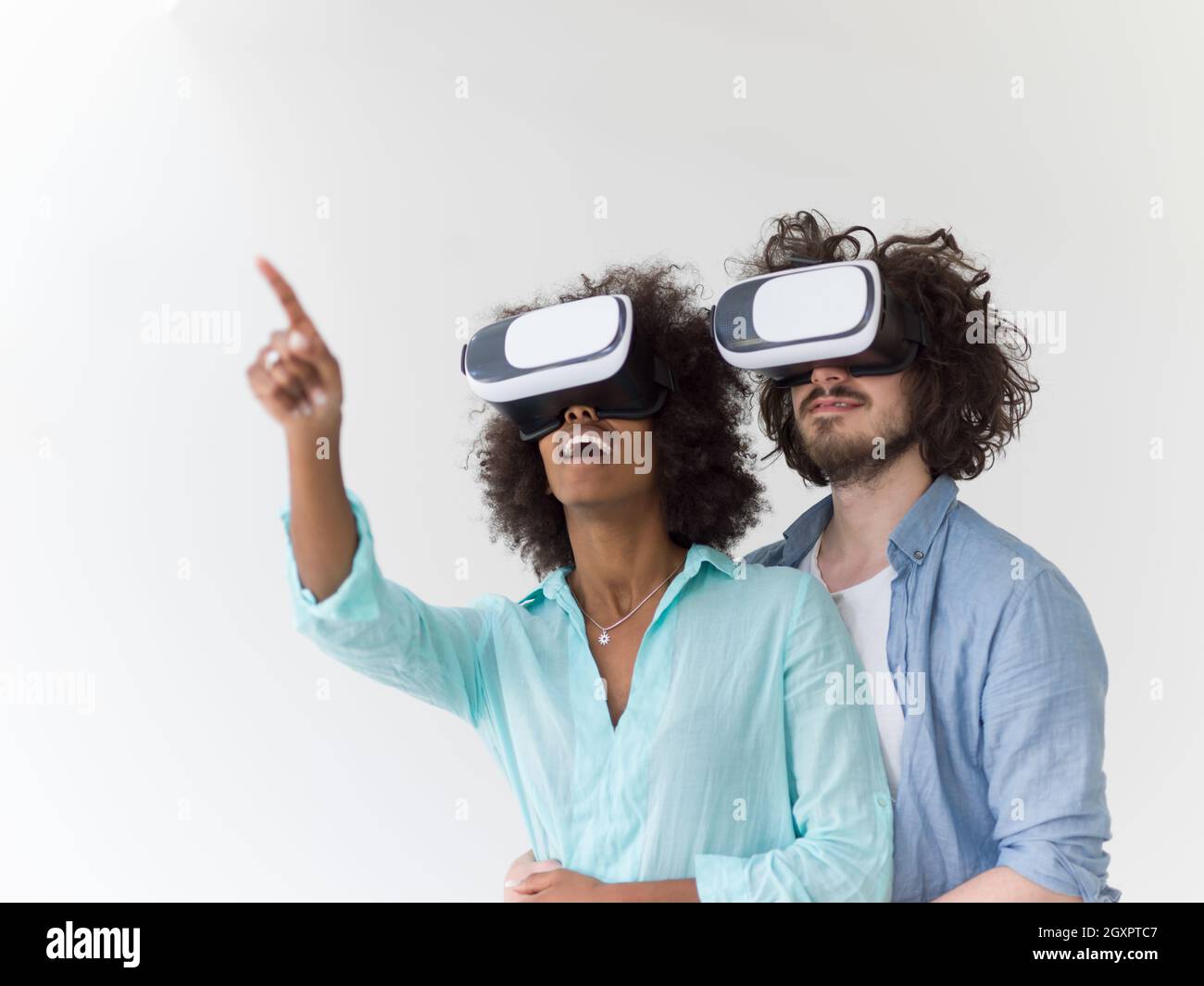 Happy multiethnic couple getting experience using VR headset glasses of ...