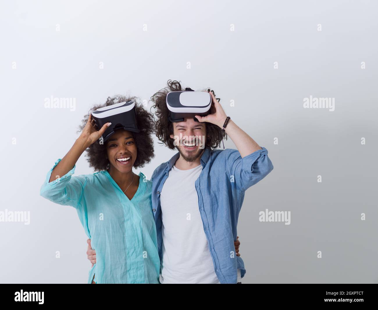 Happy multiethnic couple getting experience using VR headset glasses of ...