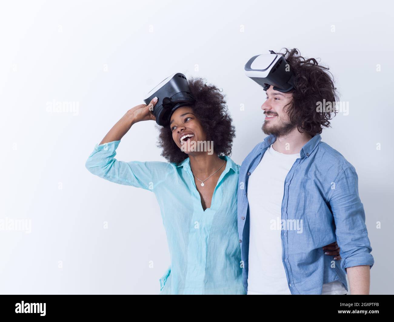 Happy multiethnic couple getting experience using VR headset glasses of ...