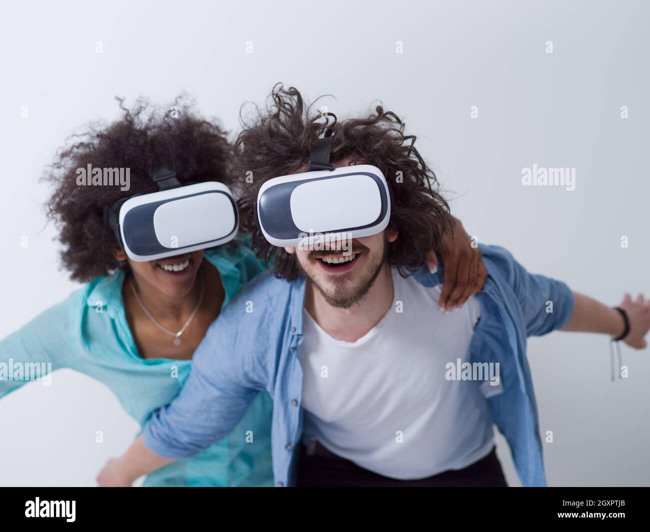 Happy multiethnic couple getting experience using VR headset glasses of ...