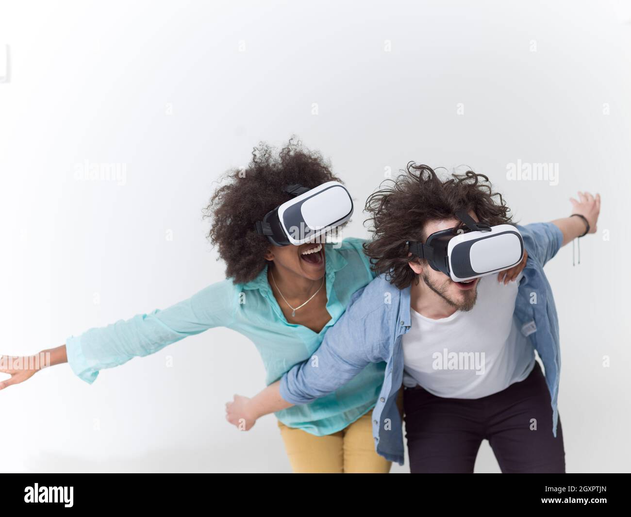 Happy multiethnic couple getting experience using VR headset glasses of ...