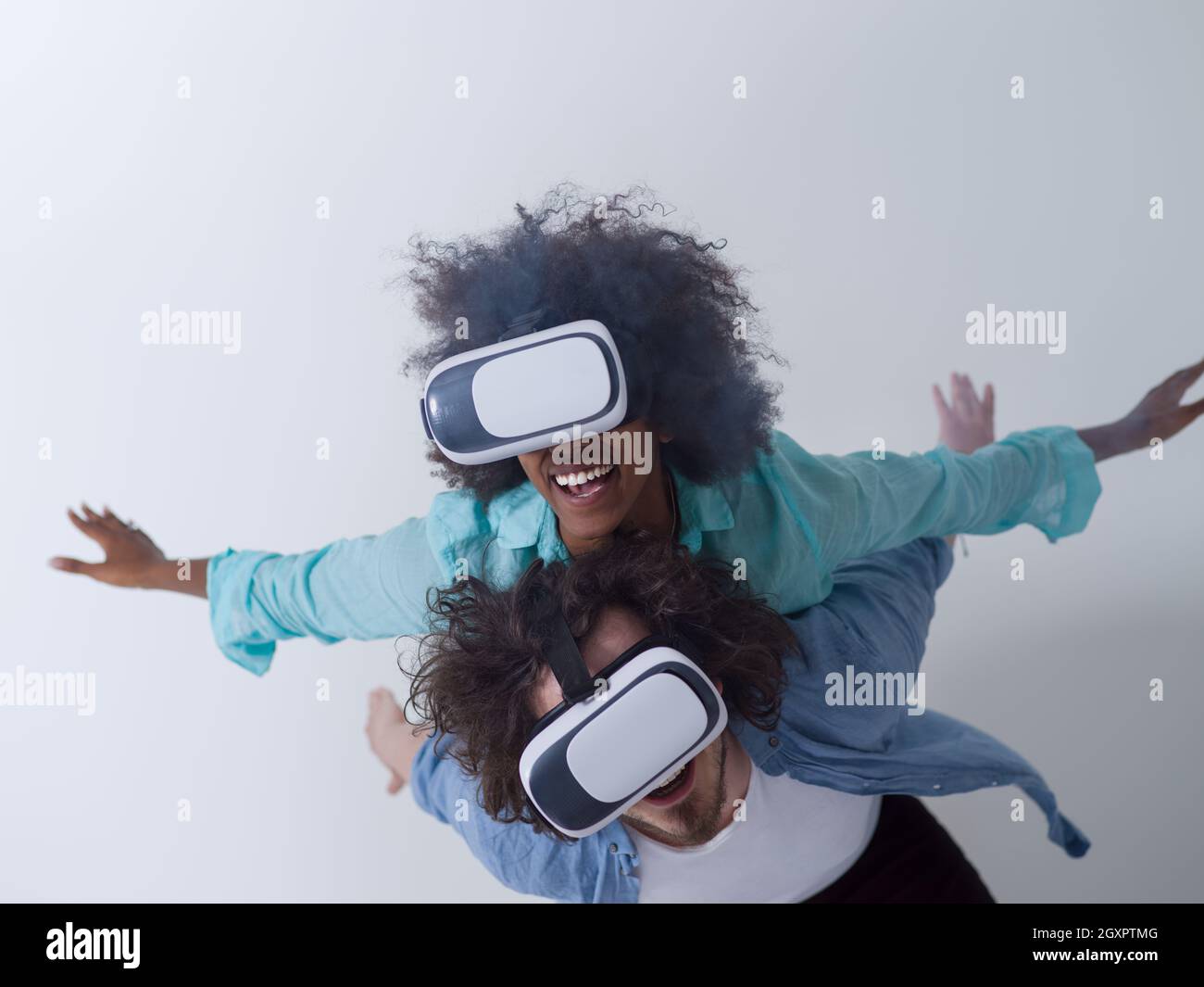 Happy multiethnic couple getting experience using VR headset glasses of ...