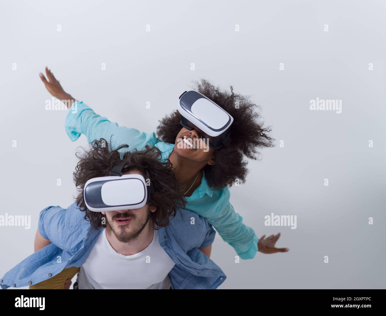 Happy multiethnic couple getting experience using VR headset glasses of ...