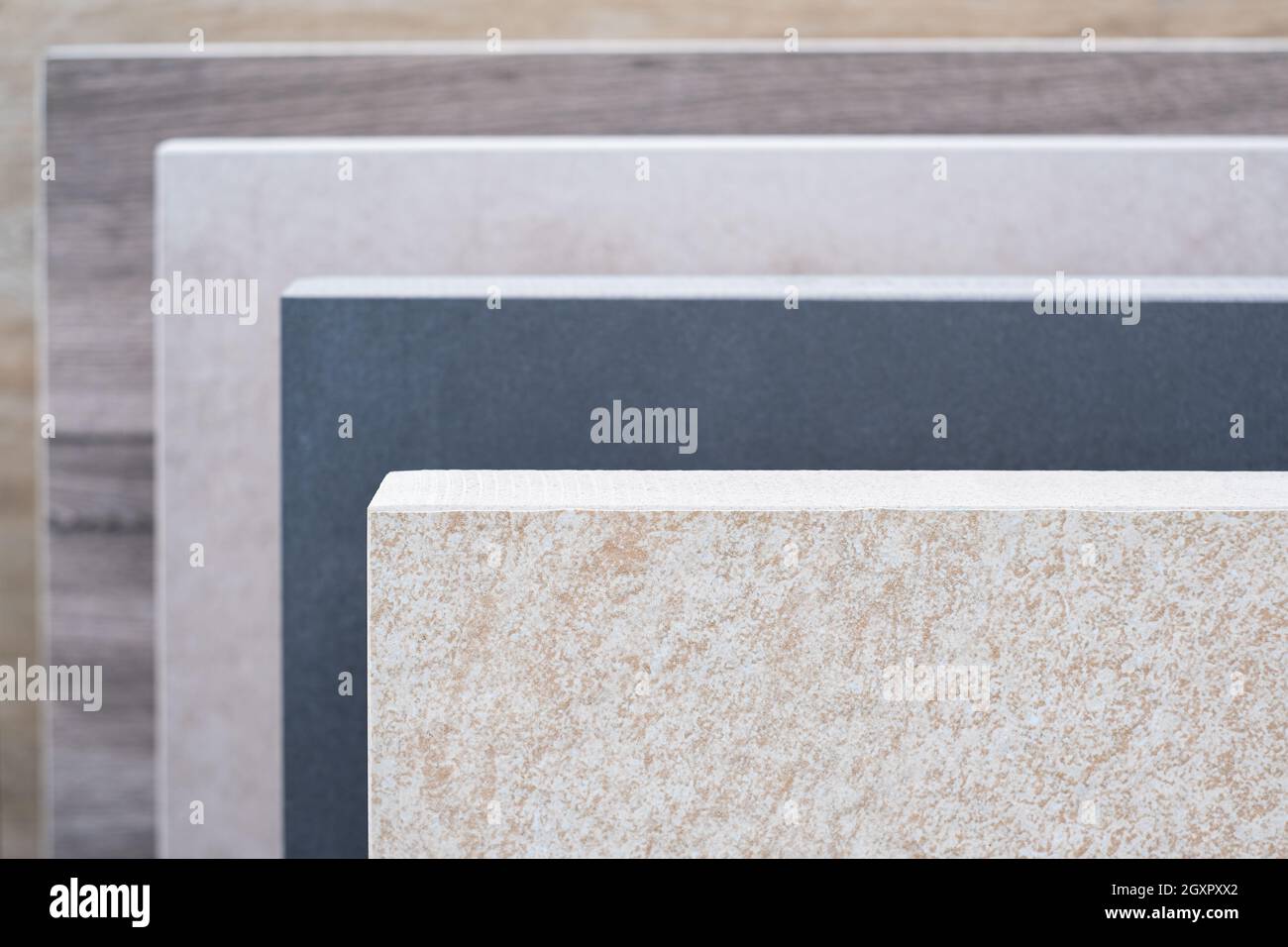 Different various large floor samples tiles in a hardware store in row ...