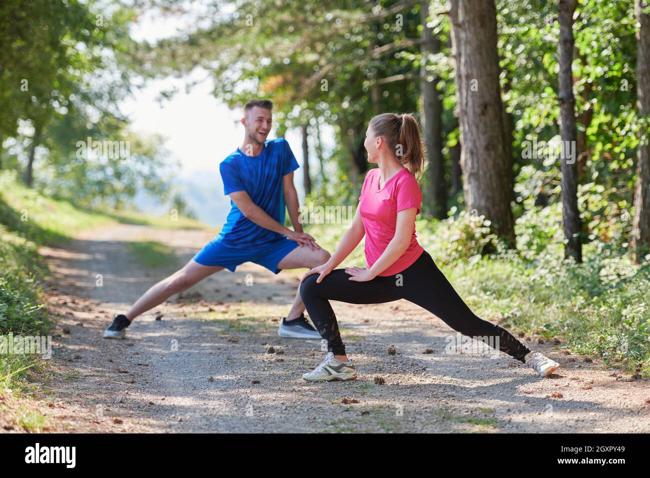 young happy couple enjoying in a healthy lifestyle warming up and ...